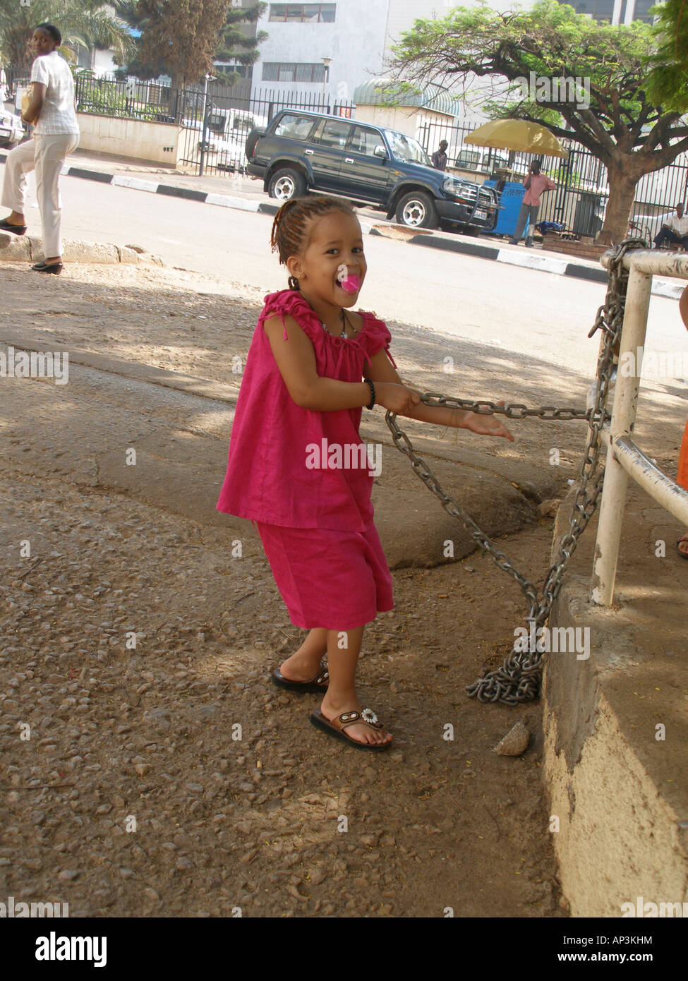 Playful girl with lollipop poses for the camera Stock Photo - Alamy