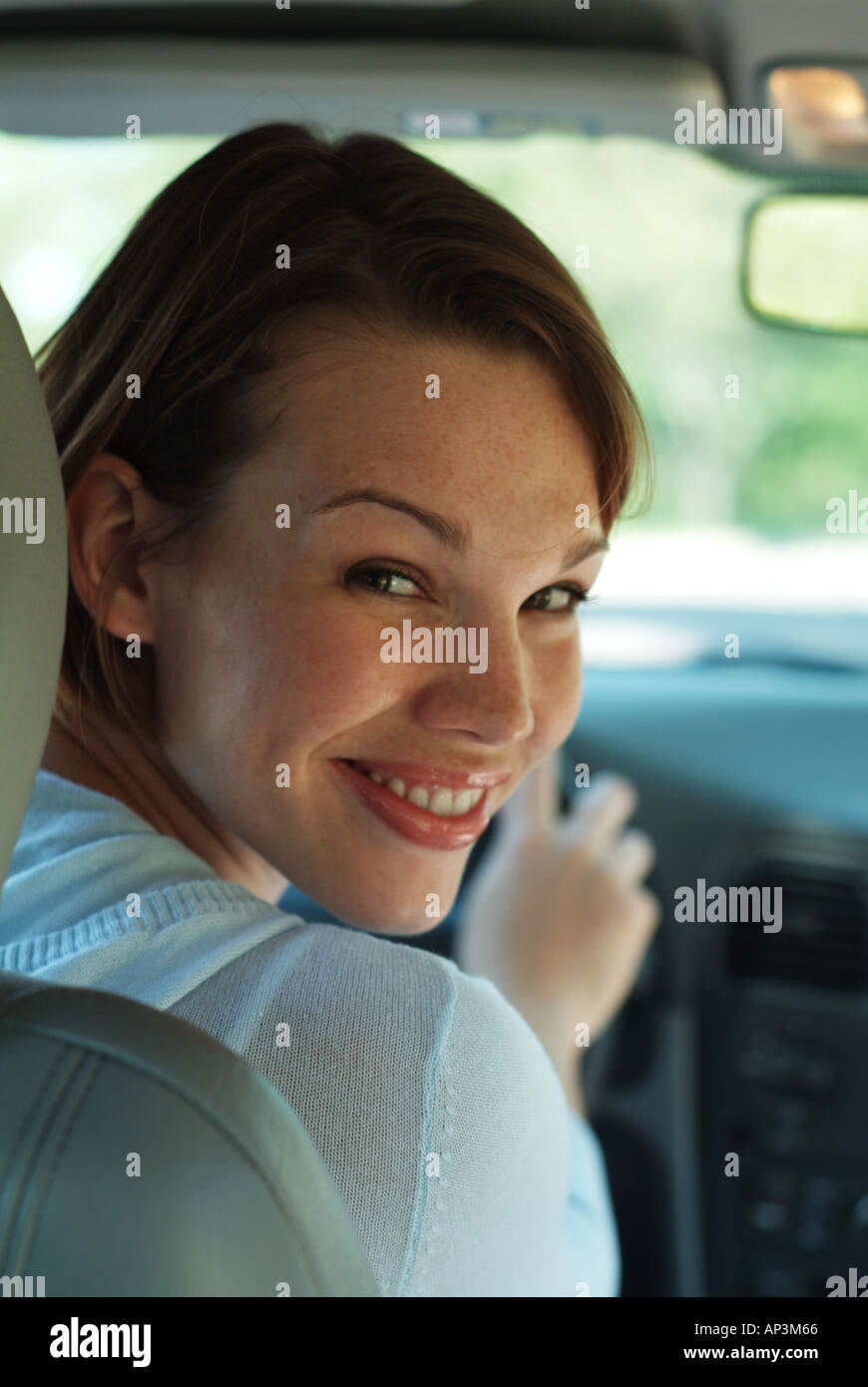 woman driving car looking back Stock Photo - Alamy
