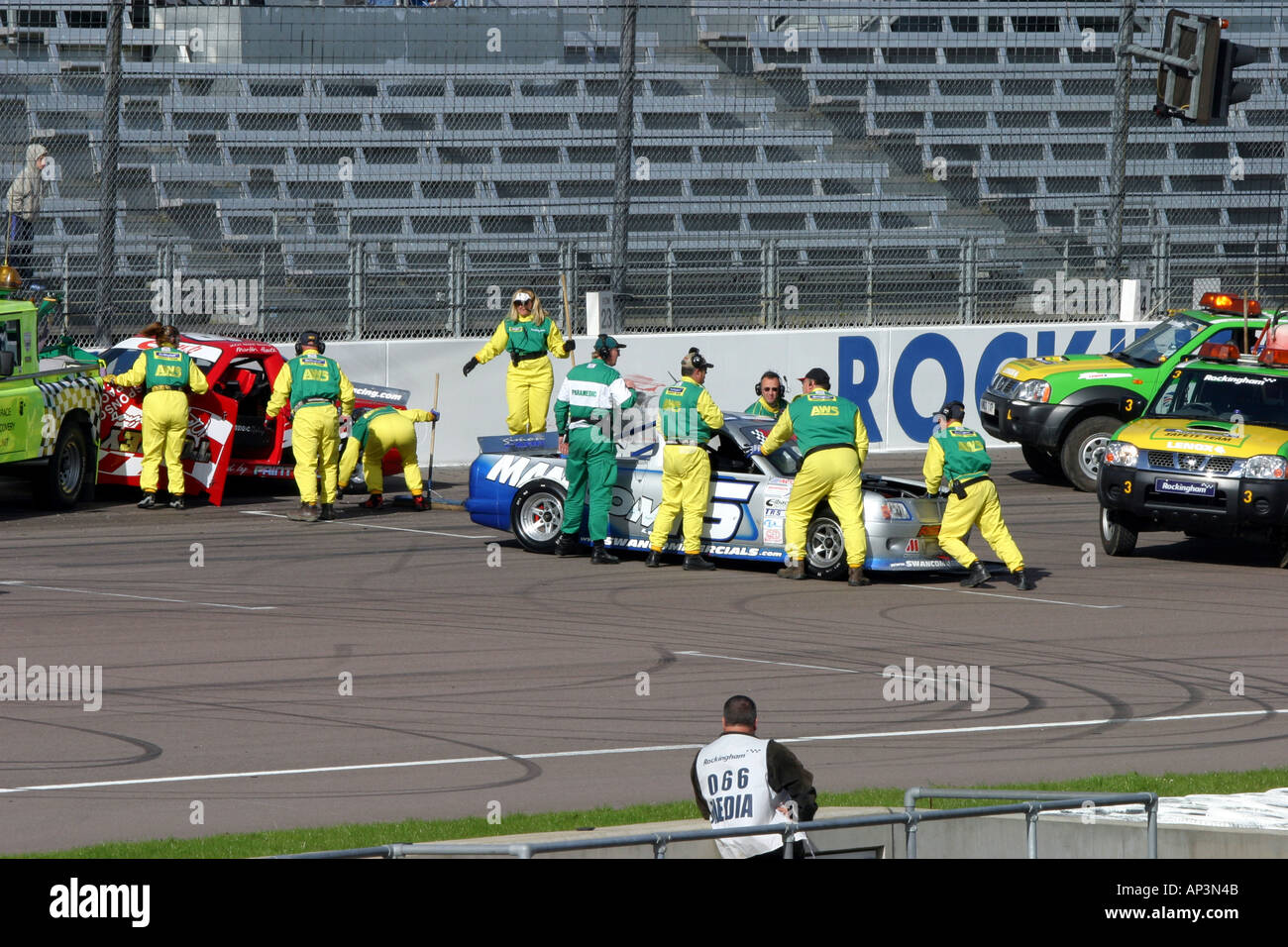 Safety crew clearing up after an accident during pick up truck racing ...