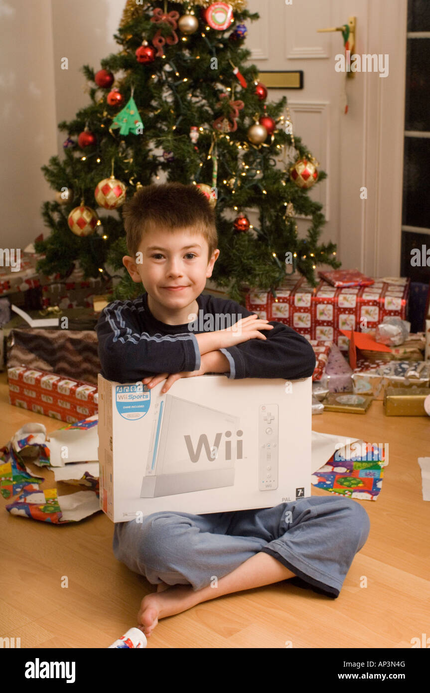 Boy unwrapping christmas presents on hi-res stock photography and ...