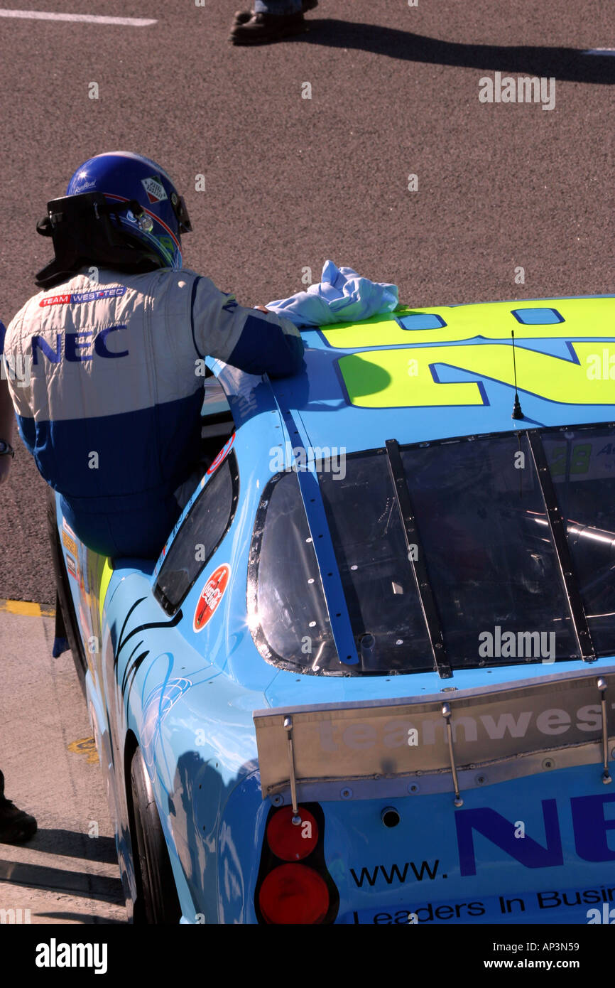 Driver getting out of V8 race car Stock Photo - Alamy