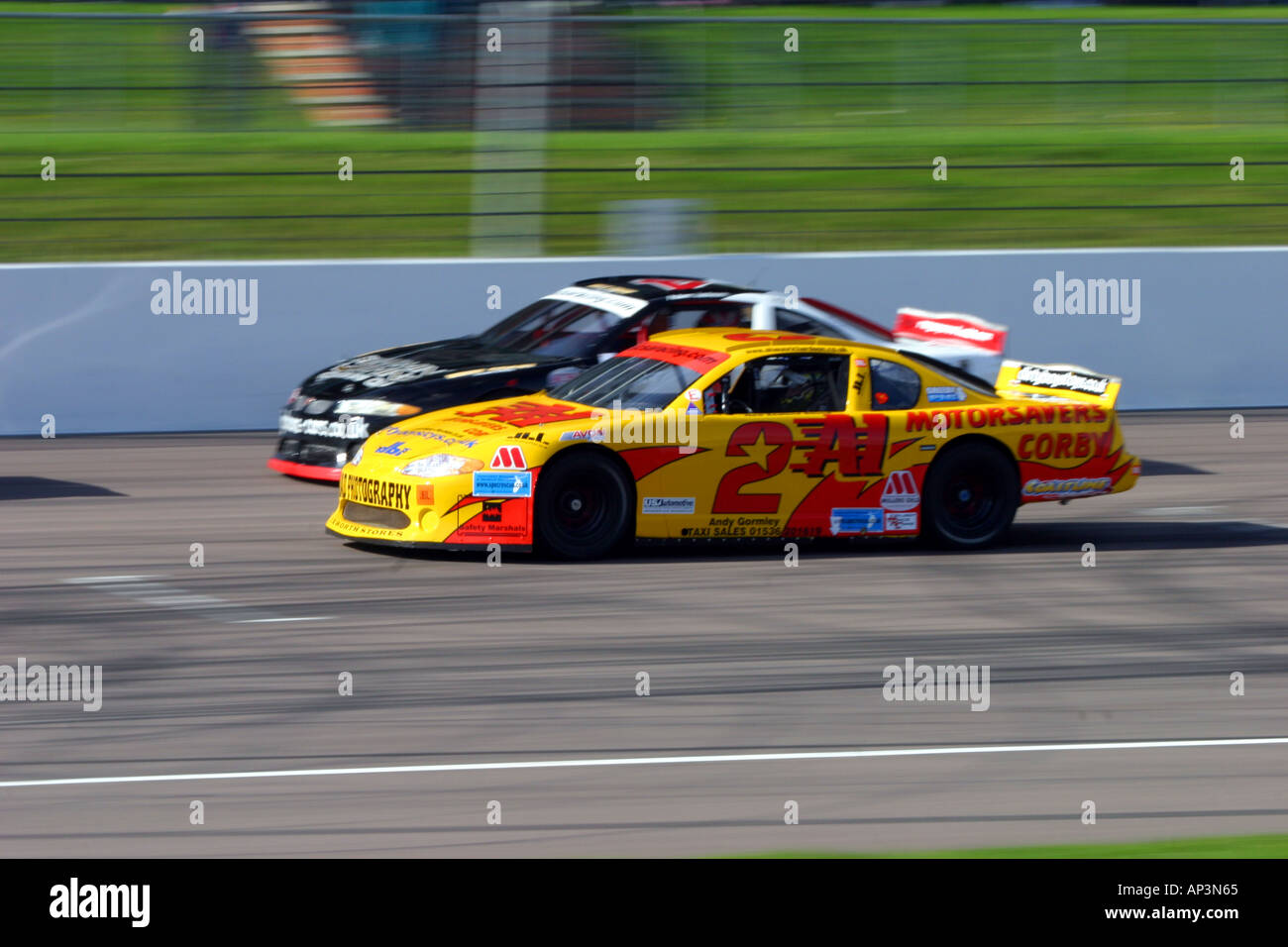 V8 Nascar type stock cars racing on a banked oval circuit Stock Photo ...