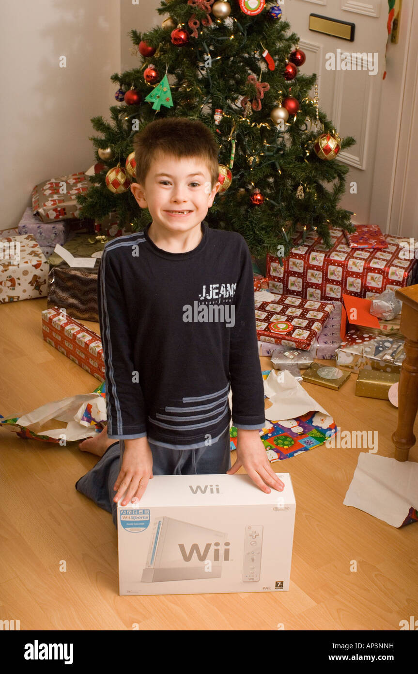 Boy Opening Presents Under Tree On Christmas Morning Stock Photo - Alamy