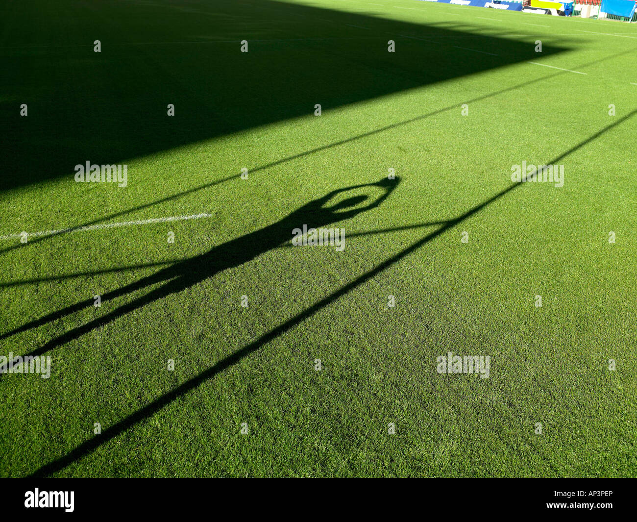 Shadow of rugby player and rugby post Stock Photo - Alamy