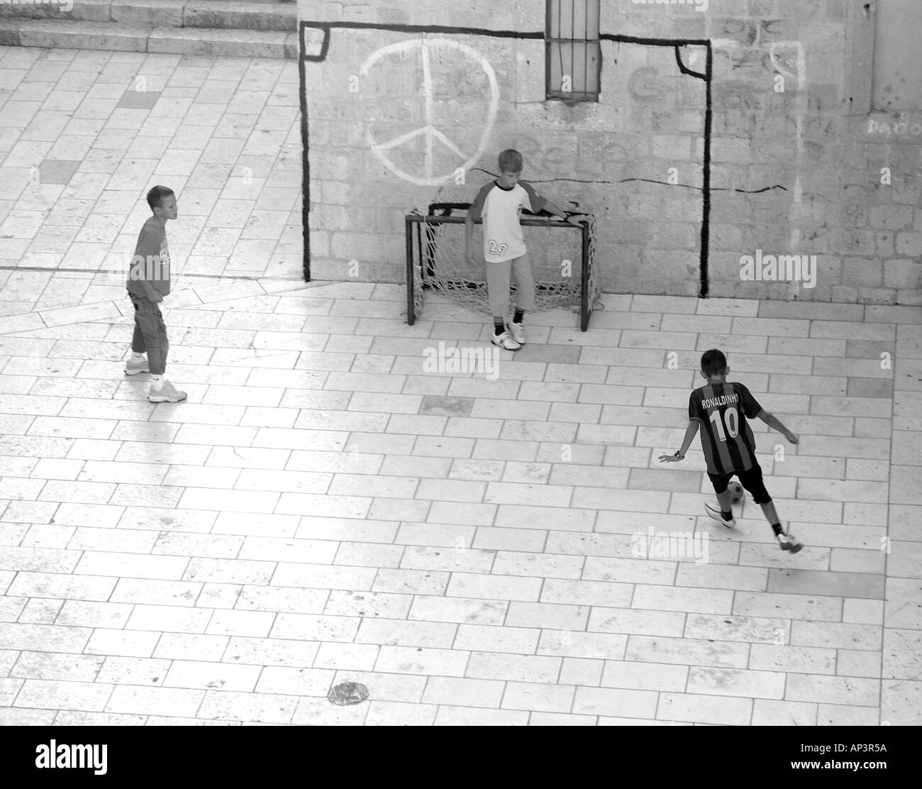 Children playing football street Black and White Stock Photos & Images ...