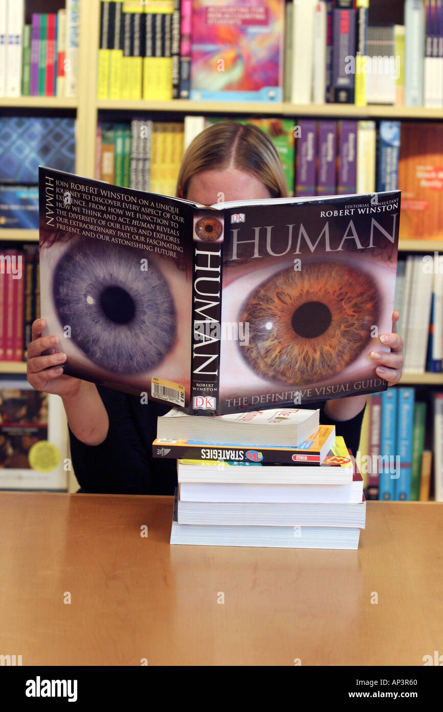 A young woman reading a large book Stock Photo - Alamy