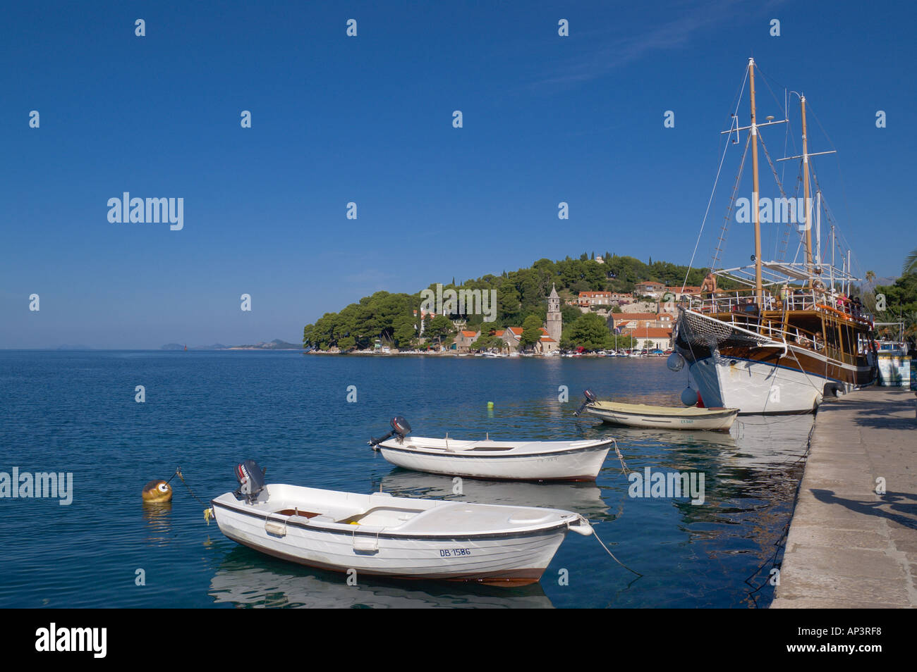 Small fishing boats and a day cruise ship in Cavtat harbour Croatia ...