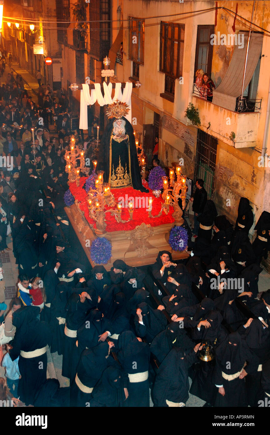 Good Friday night procession through narrow streets of Malaga , Spain ...