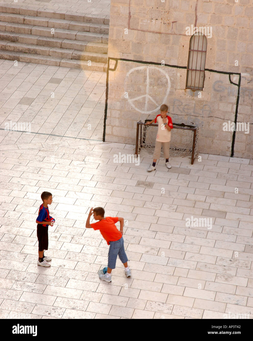 Child shouting at another during an urban football match Stock Photo ...