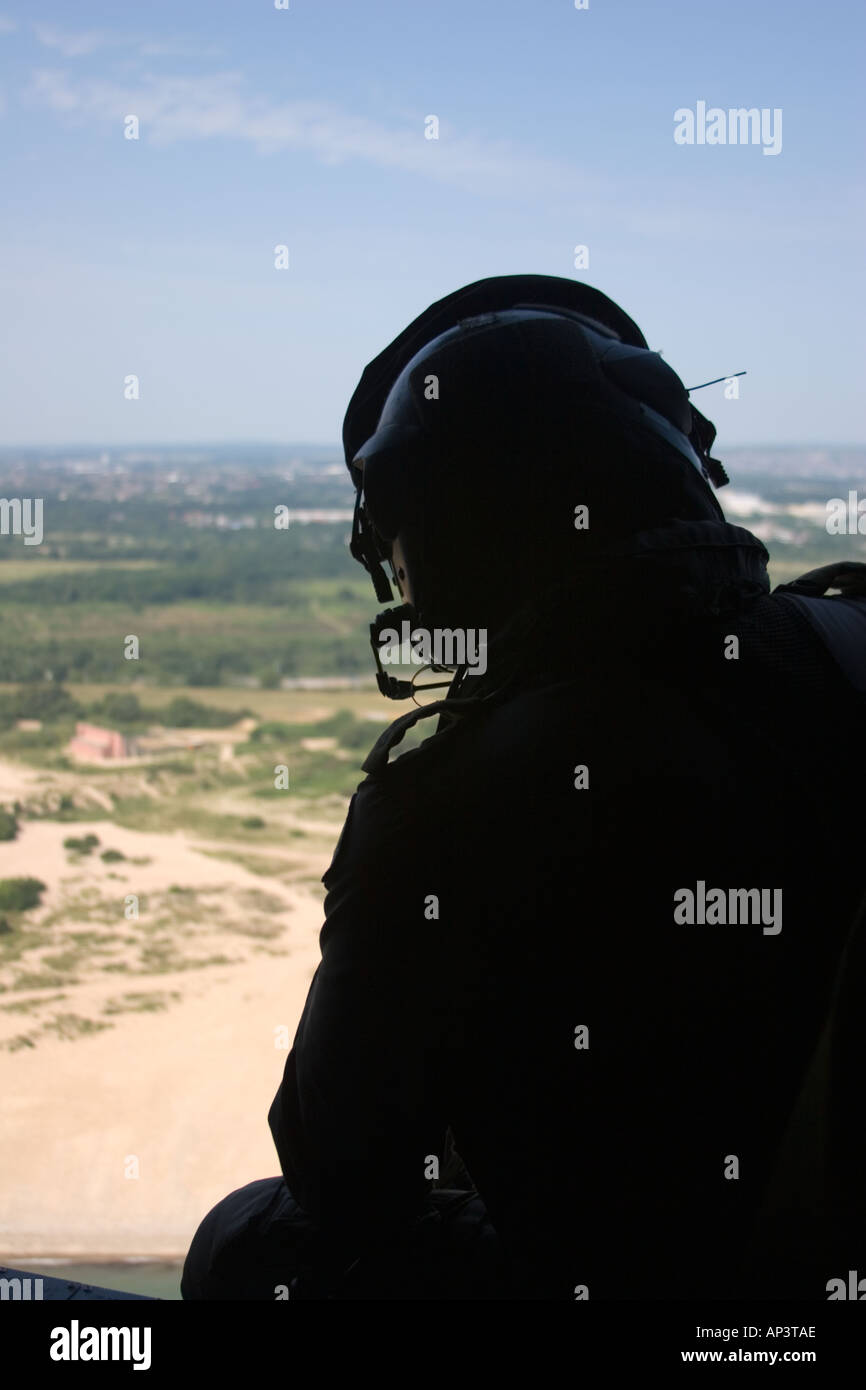 crew member of helicopter looks out at view Stock Photo - Alamy