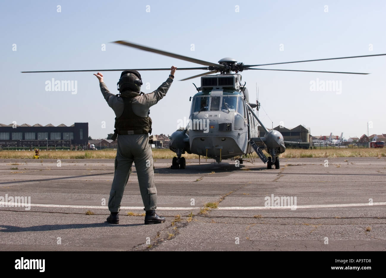 man directing helicopter at take off Stock Photo - Alamy