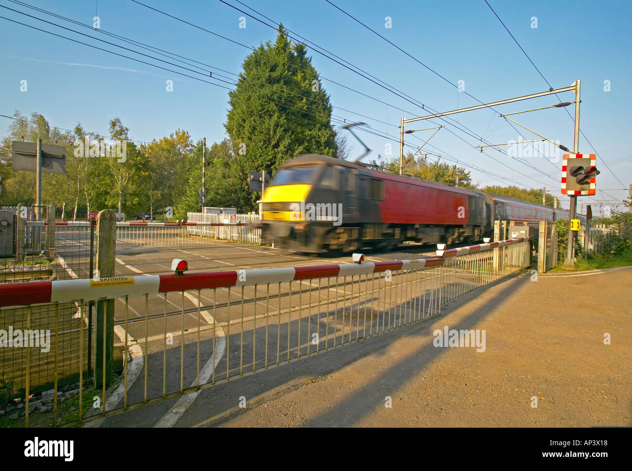 automatic barriers at a road rail crossing essex ux Stock Photo - Alamy