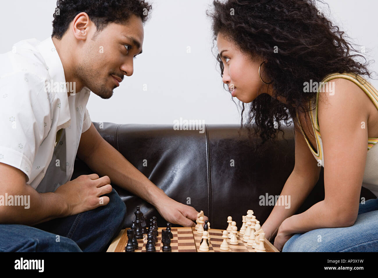Couple playing chess Stock Photo - Alamy