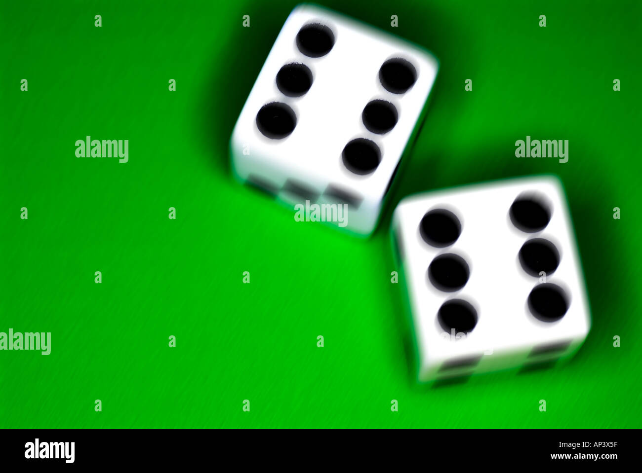 two white dice on green background Stock Photo - Alamy