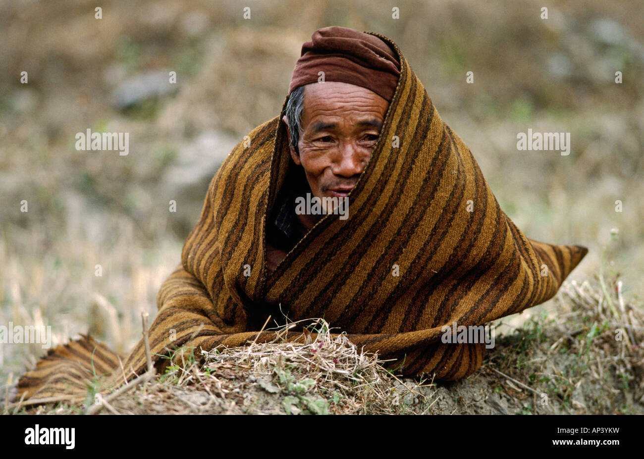 OLD GURUNG MAN wearing traditional WOOL BLANKET in the DORDI RIVER ...