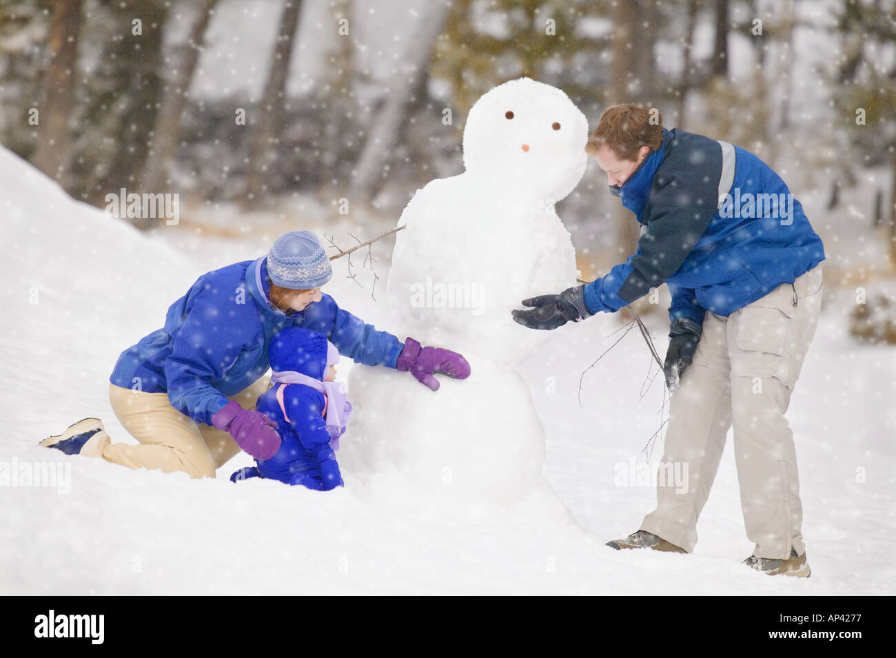 Building a snowman Stock Photo - Alamy