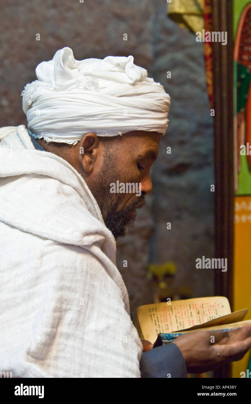 A priest reads from religious text in the Bete Maryam mononlithic ...