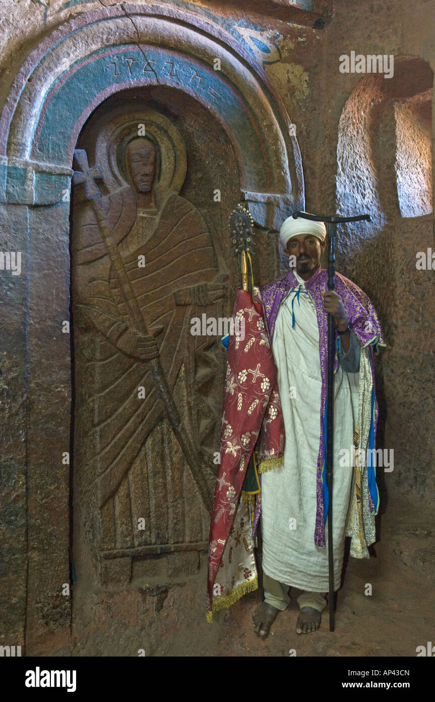 A priest poses for the camera in the Bete Mikael monolithic church in ...