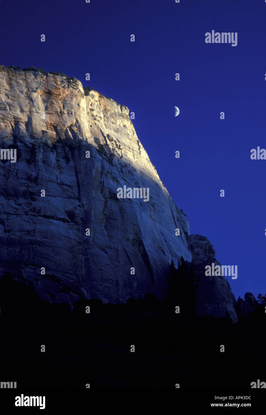 Mountain cliff with deep blue sky and quarter moon Stock Photo - Alamy