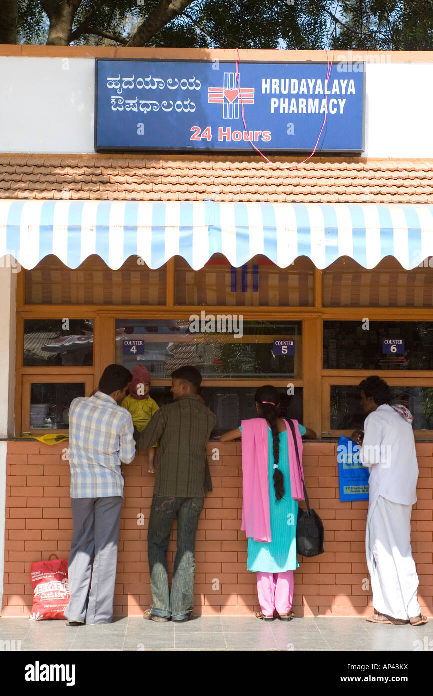 People queue to buy and receive medicines from the dispensing counter ...