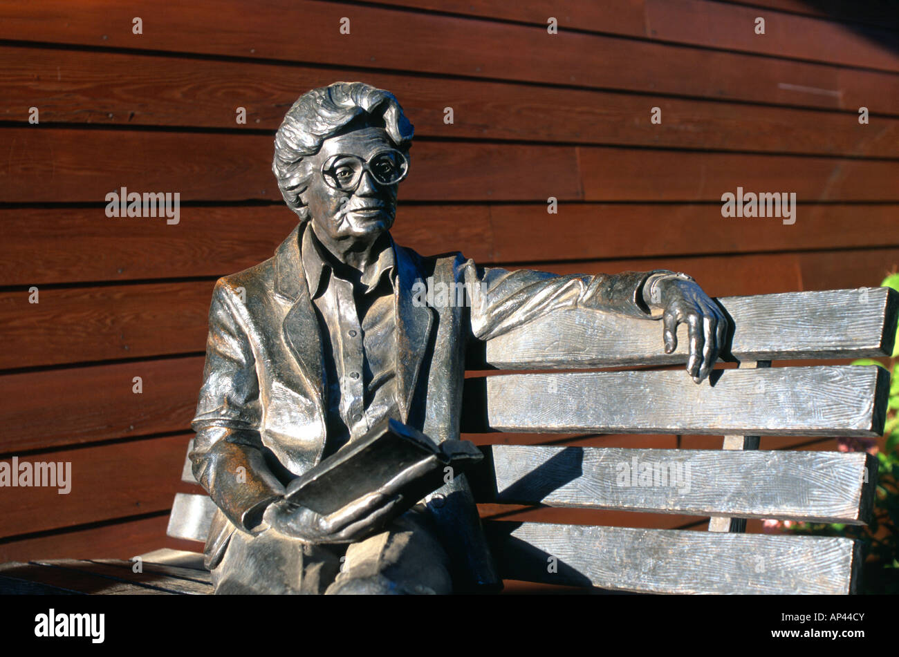 Statue of woman on bench reading book Stock Photo - Alamy