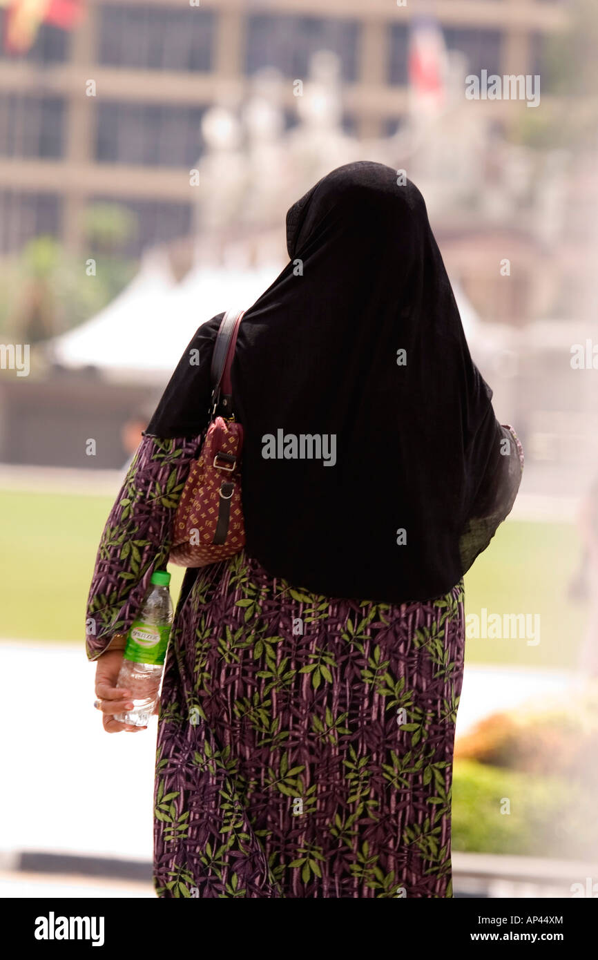 A veiled Muslim woman walks near to Merdeka Square in Kuala Lumpur ...