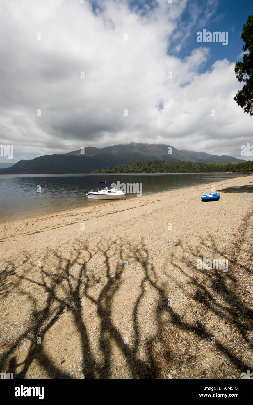 Power boat moored on the shores of Lake Brunner Stock Photo - Alamy