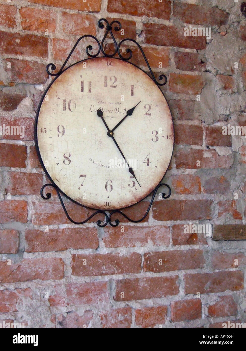 An antique clock mounted on the wall in the interior of an old building ...