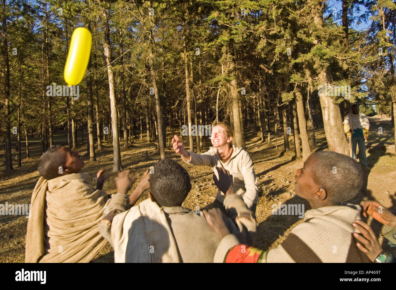A tourist playing with local children trying to catch a ballon Stock ...