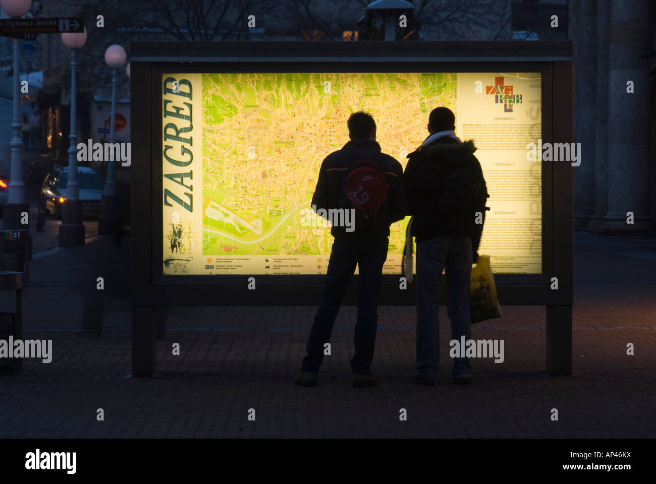 Two people looking at an illuminated tourist map of Zagreb in the main ...