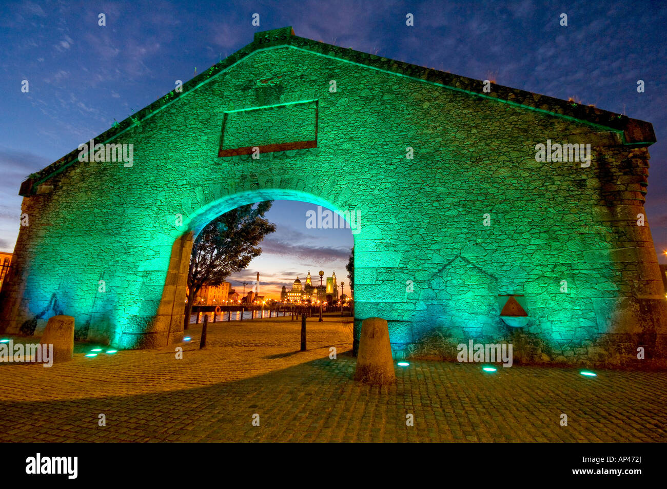 View through the Wapping Arch at night showing the Albert Dock ...