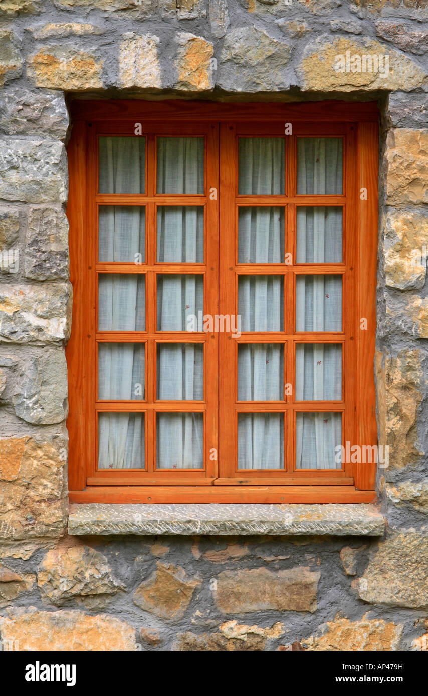 Wooden rustic vertical window on an stone wall Stock Photo - Alamy