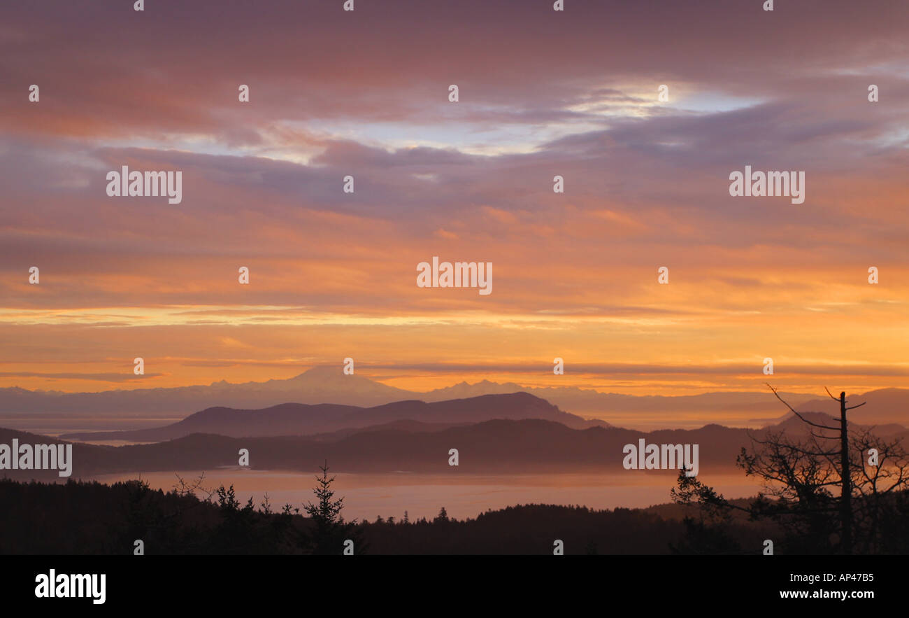 Sunset through clouds Stock Photo - Alamy