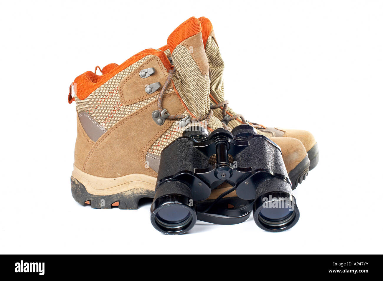 Used hiking boots and binoculars with soft shadow on white background ...