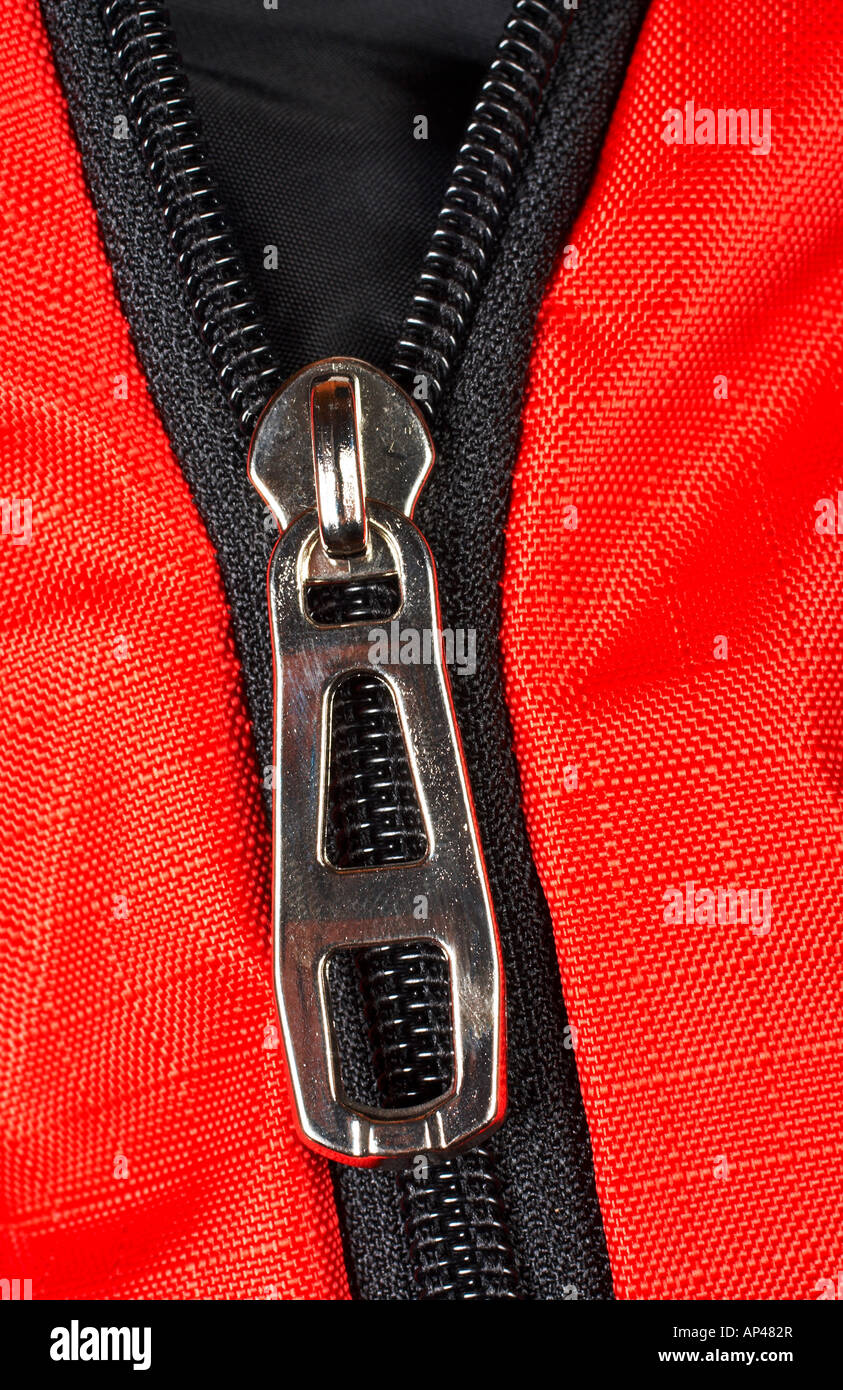 Red fabric and a chrome zipper opened Stock Photo - Alamy