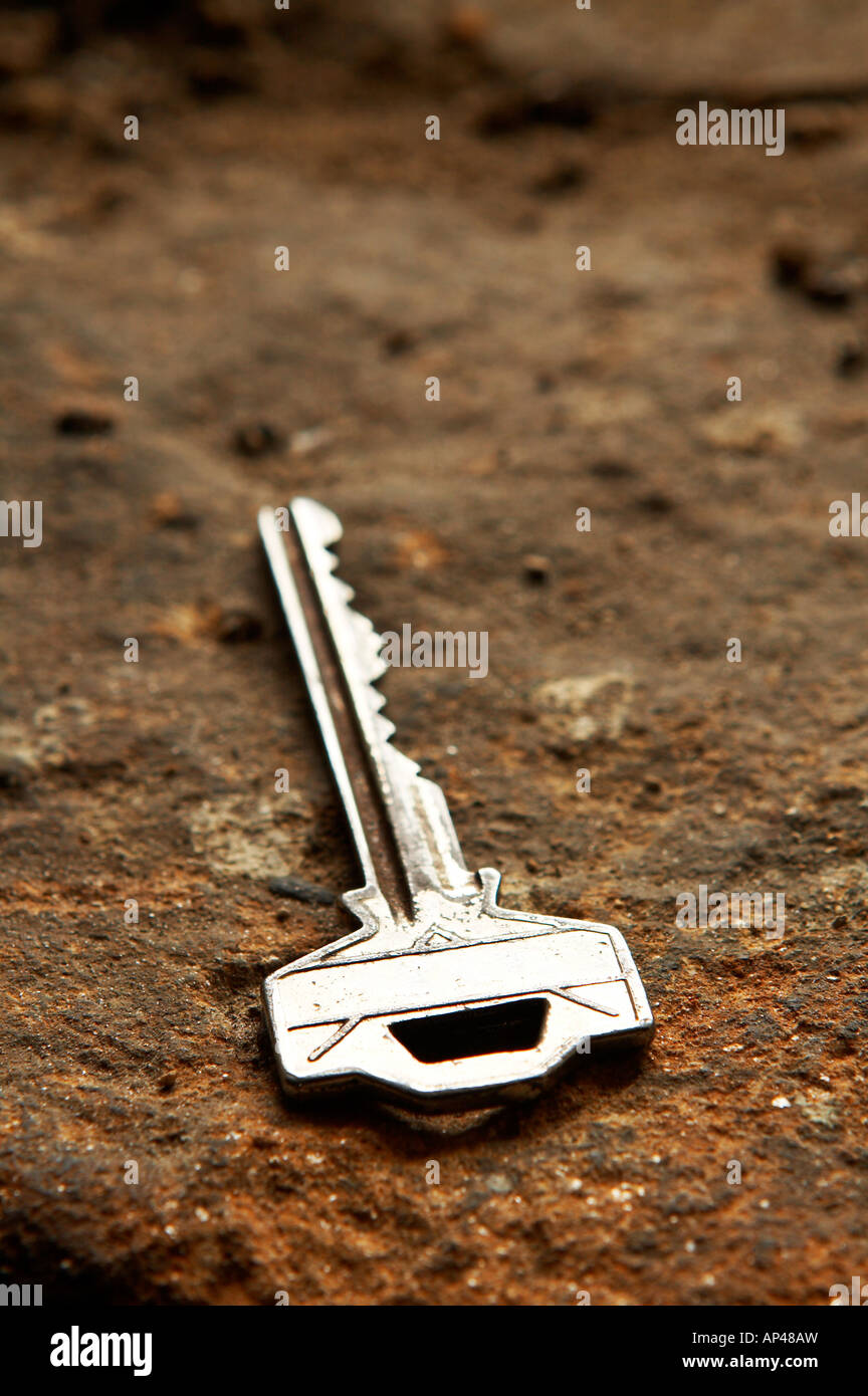A bright key with shadow over the stone background Shallow DOF Stock ...