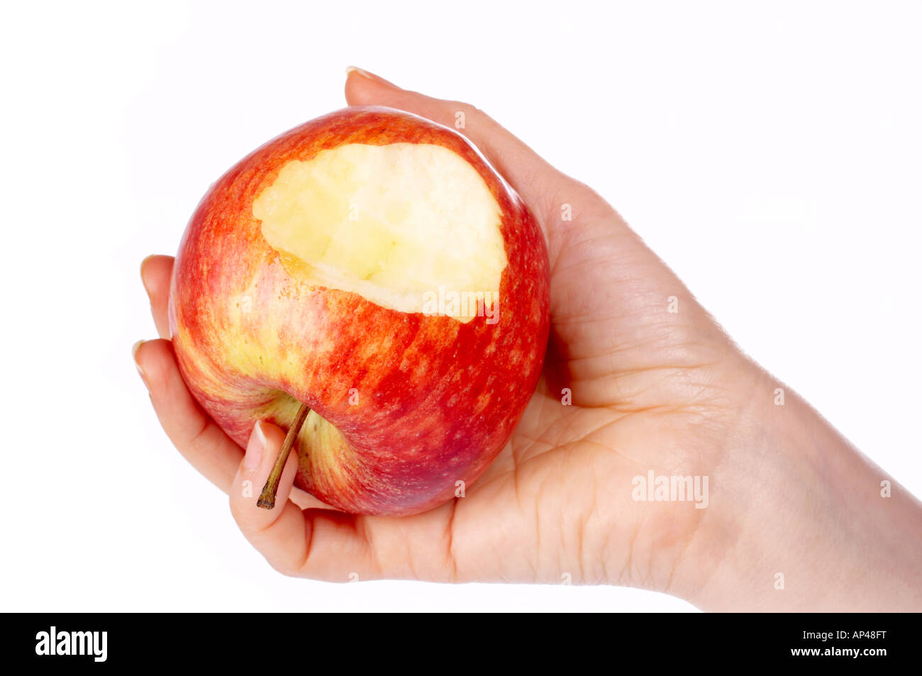 Bitten red apple in hand on the white background Stock Photo - Alamy
