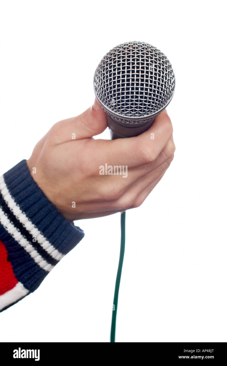 Hand holding a microphone over a white background Mic on focus Stock ...