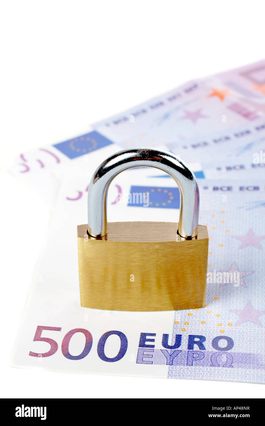 Locked padlock and money over a white background Stock Photo - Alamy