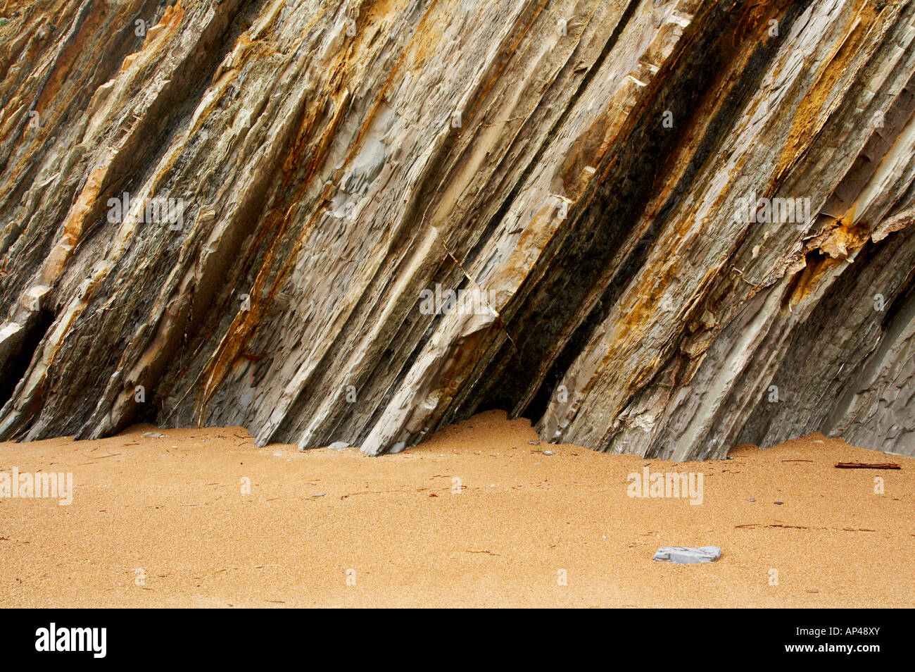 Multiple layers of eroded cliff in a beach Stock Photo - Alamy
