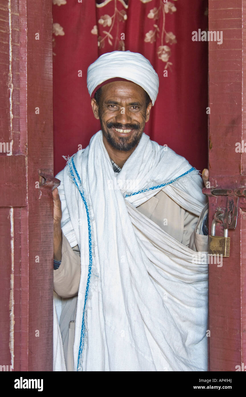 A priest poses for the camera in the Bete Mecurios mononlithic church ...