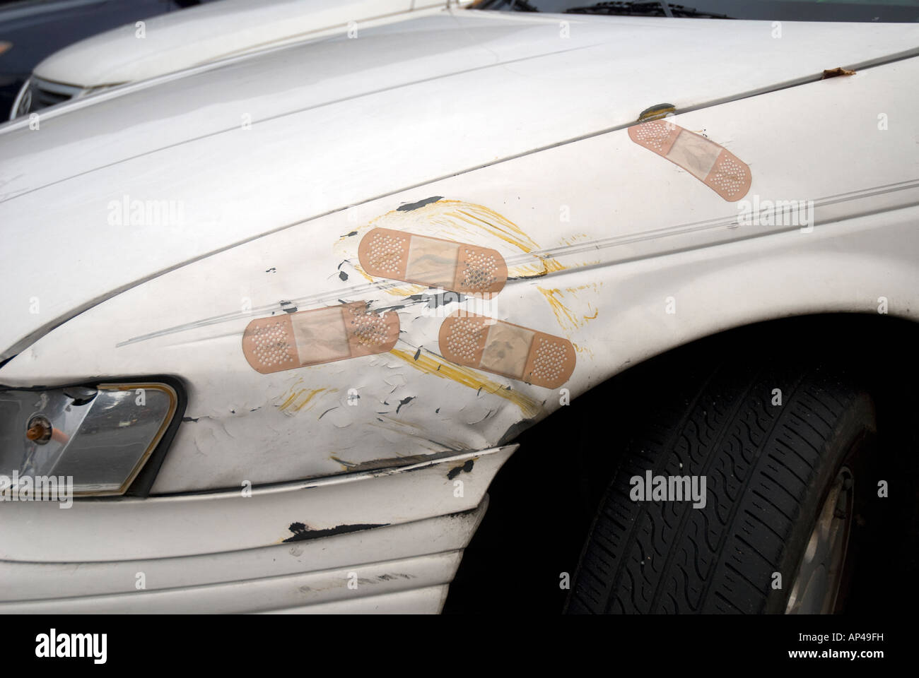 automobile with giant band aids covering accident damage Stock Photo ...