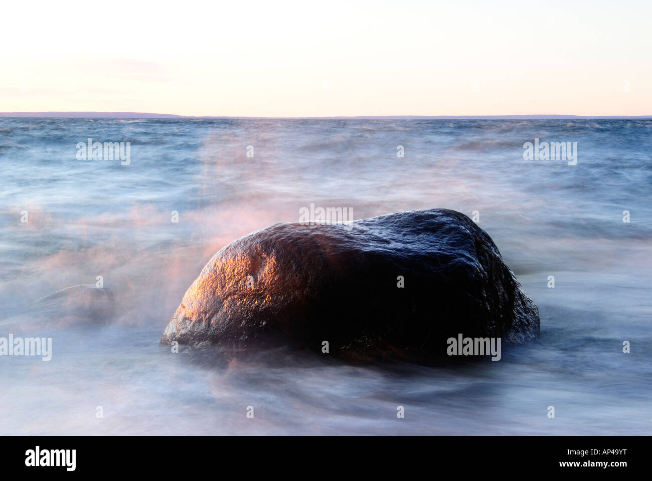 Mist over rock in Lake Vattern at dawn, Sweden Stock Photo - Alamy