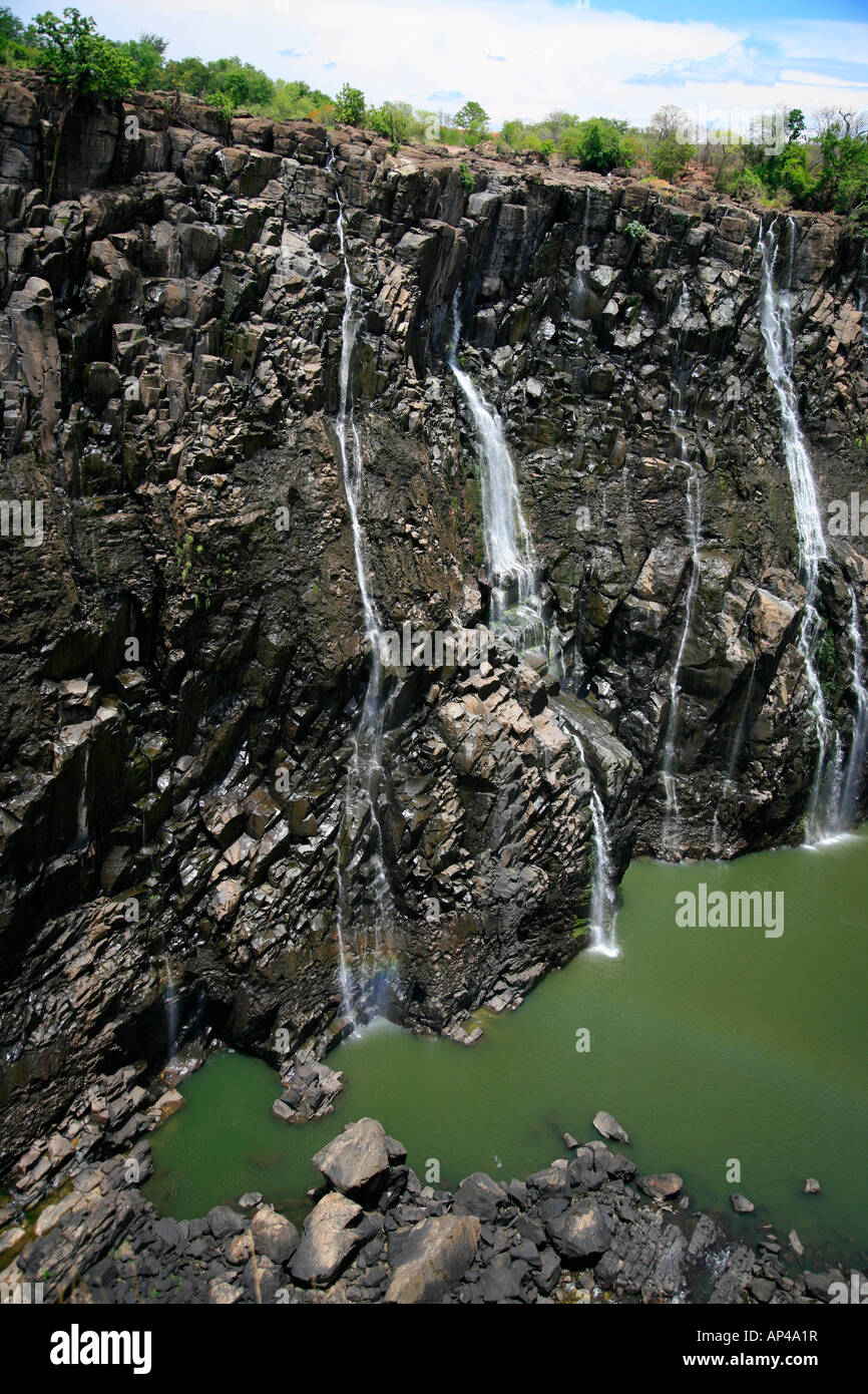 Dried out low water streams with rainbow over rocks with trees ...