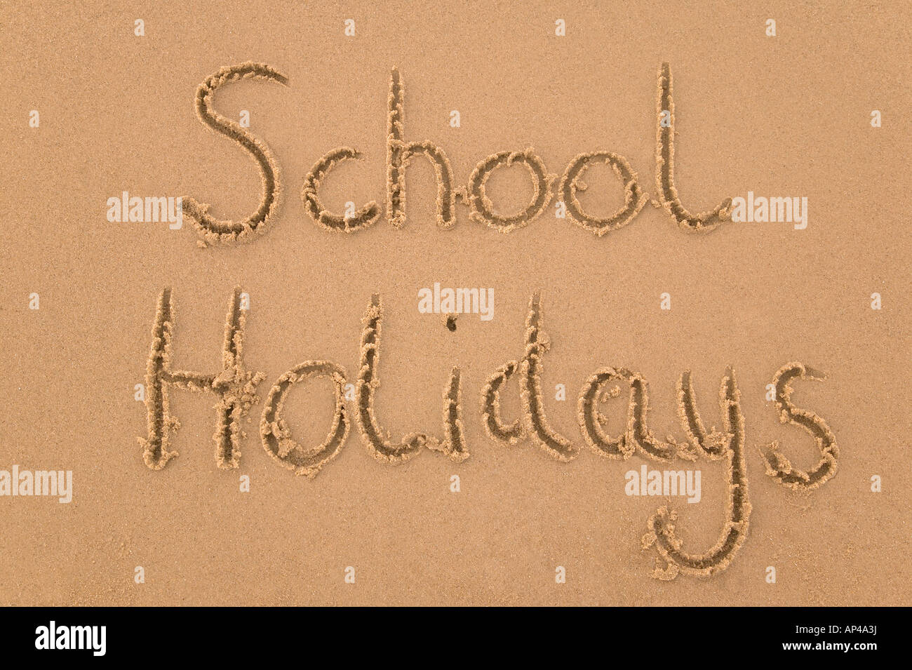 School Holidays handwritten in sand Stock Photo - Alamy