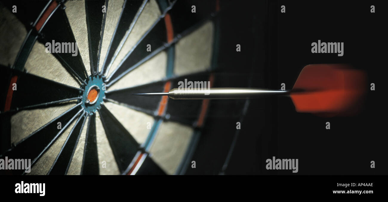Dart flying to dartboard Stock Photo - Alamy
