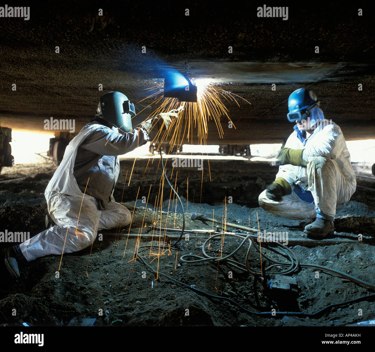 Workers welding hull of ship Stock Photo - Alamy