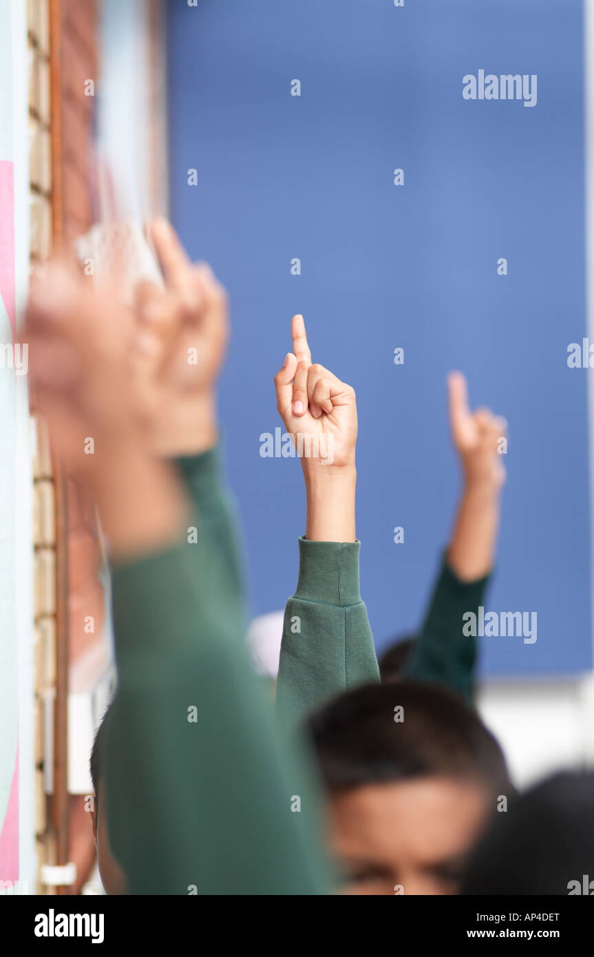 Kids in class hands up hi-res stock photography and images - Alamy