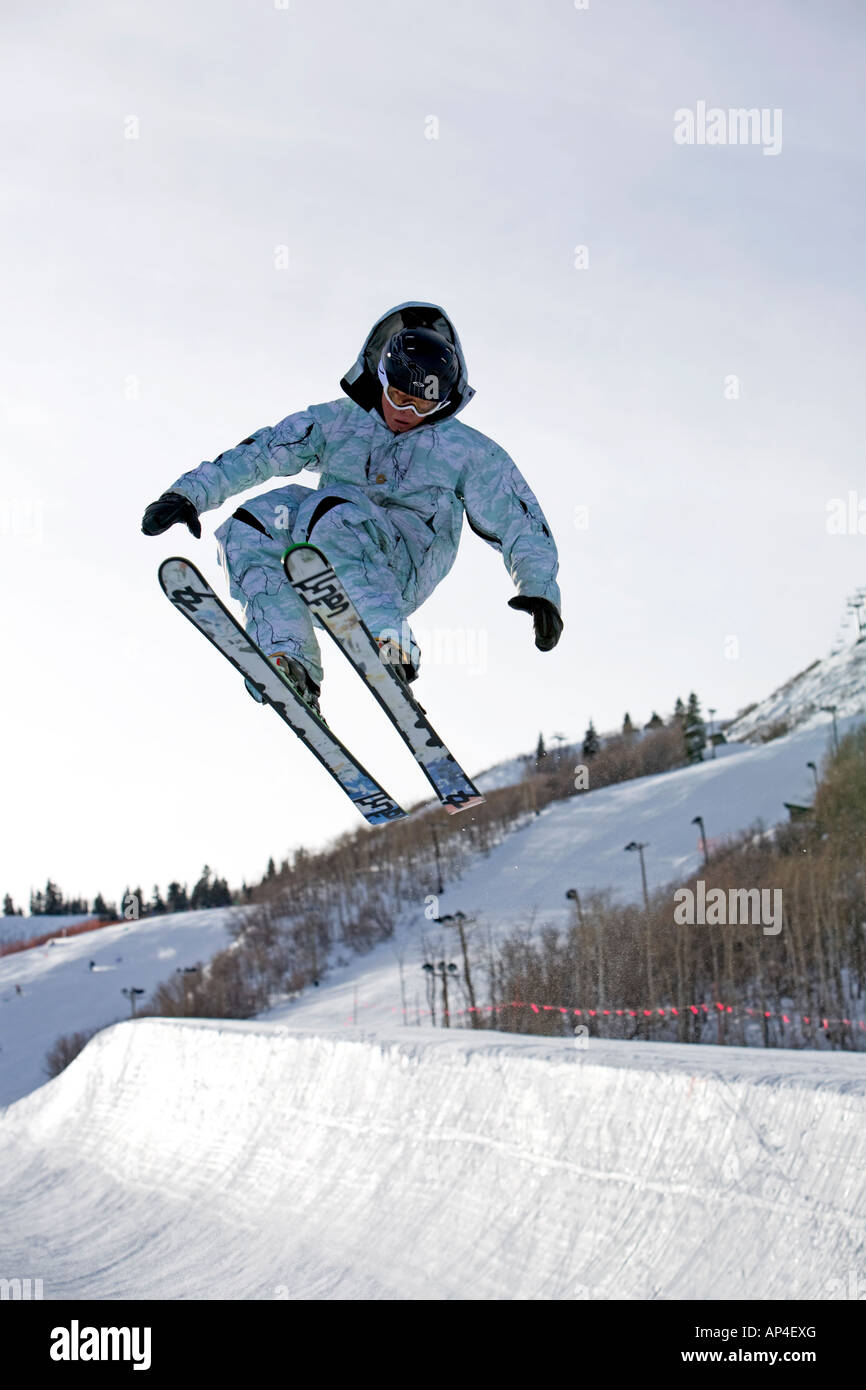 Ski run snow with a boy jumping above the rim in Park City, Utah Stock ...