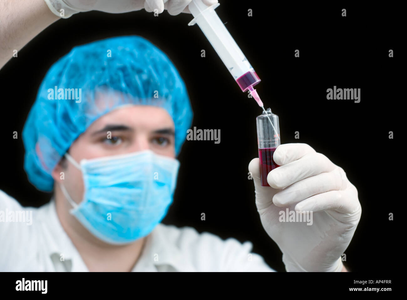Medical worker examining a blood sample Stock Photo - Alamy